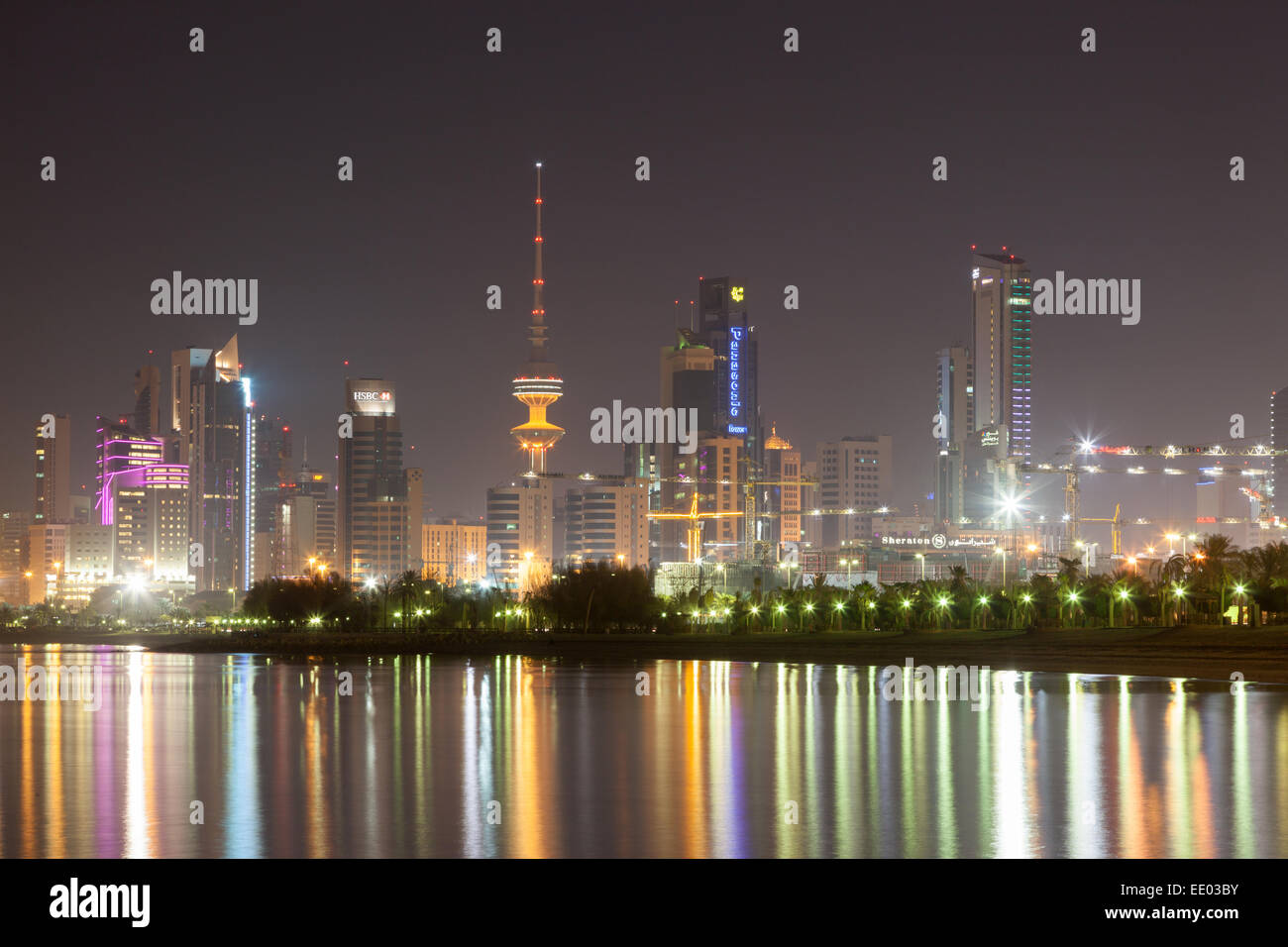 Skyline of Kuwait City illuminated at night Stock Photo - Alamy