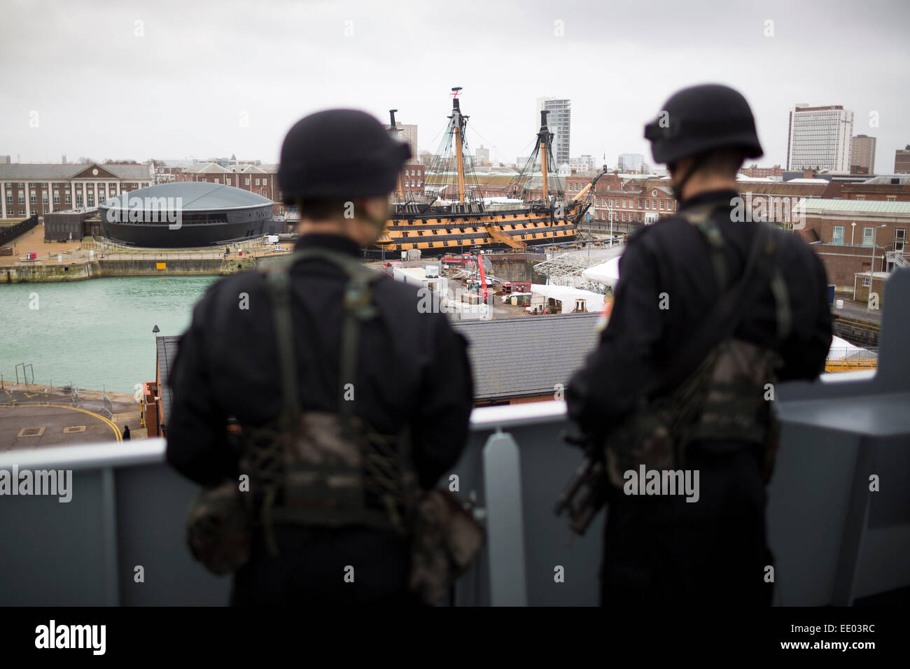 Sailors from the Chinese Naval assault ship Chang Bai Shan look across ...