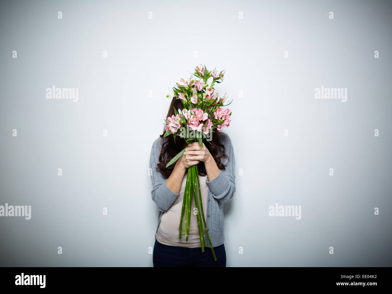 Young woman behind big bouquet Stock Photo - Alamy
