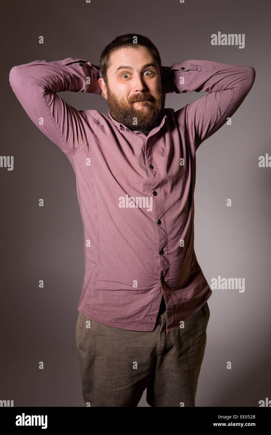 young casual silly man in a dark background Stock Photo - Alamy