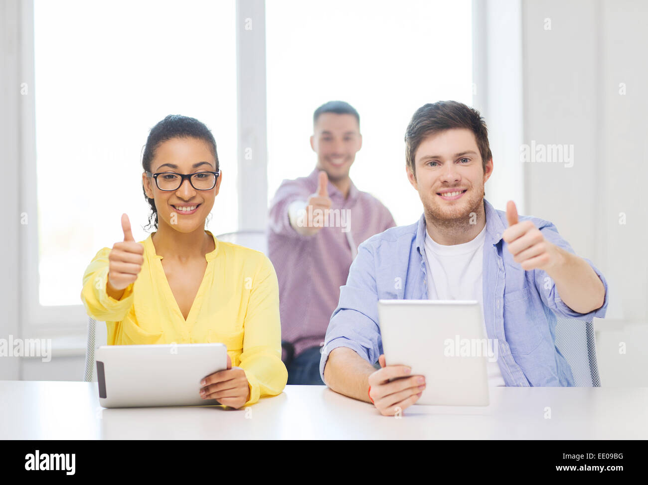 smiling team with tablet pc computers at office Stock Photo - Alamy
