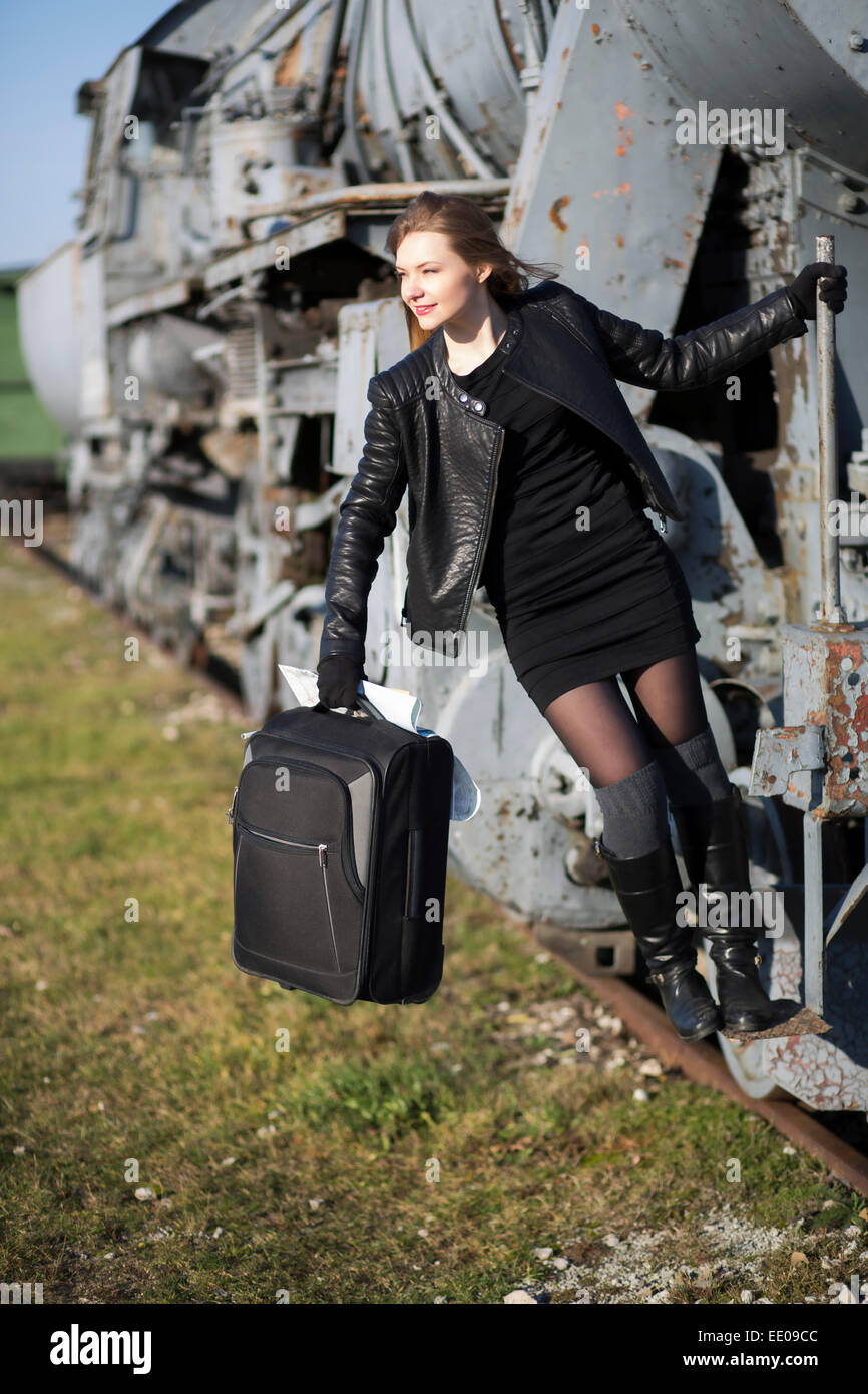 Woman is ready to jump off mowing train Stock Photo - Alamy