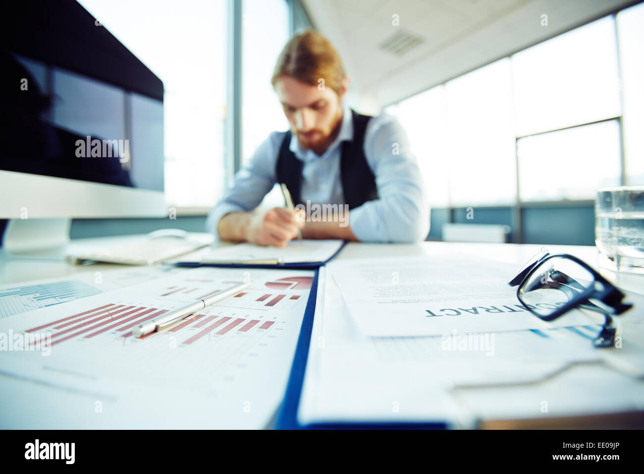 Office worker busy working with papers Stock Photo - Alamy