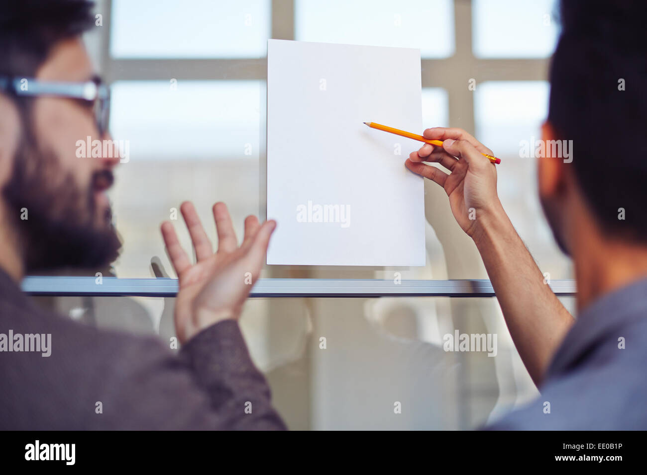 Male manager pointing at blank paper on noticeboard with pencil Stock ...