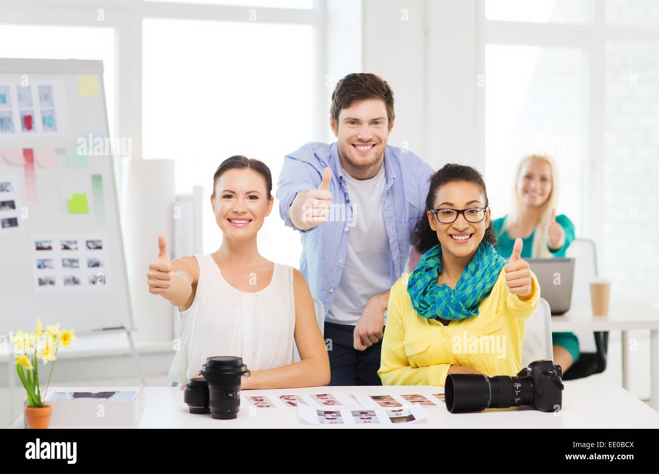 smiling team with photocamera in office Stock Photo - Alamy
