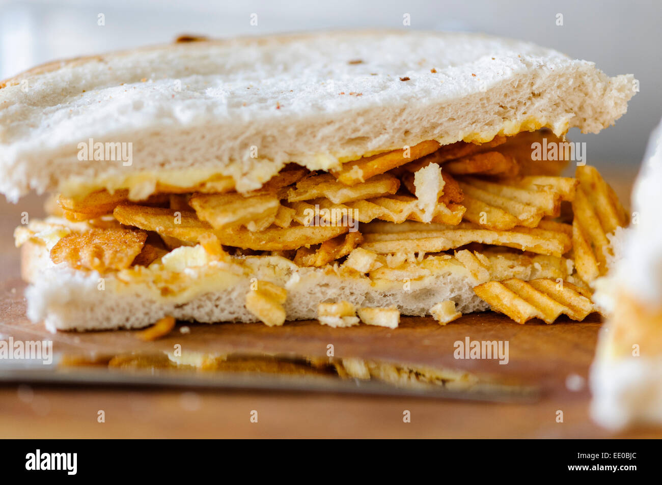A crisp sandwich comprising a packet of ridged crisps inside two slices ...