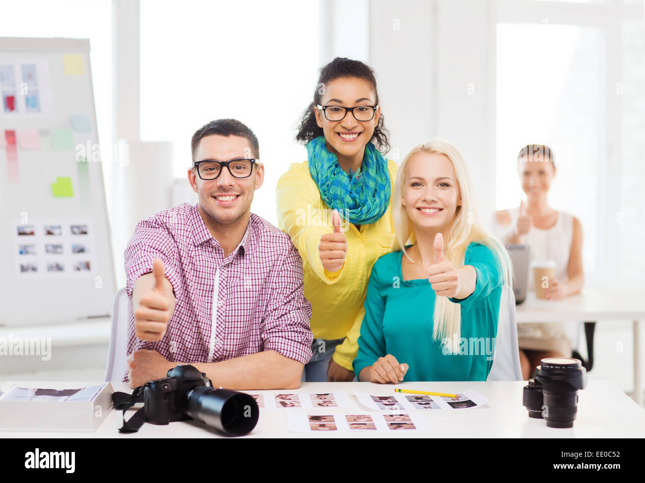 smiling team with printed photos working in office Stock Photo - Alamy
