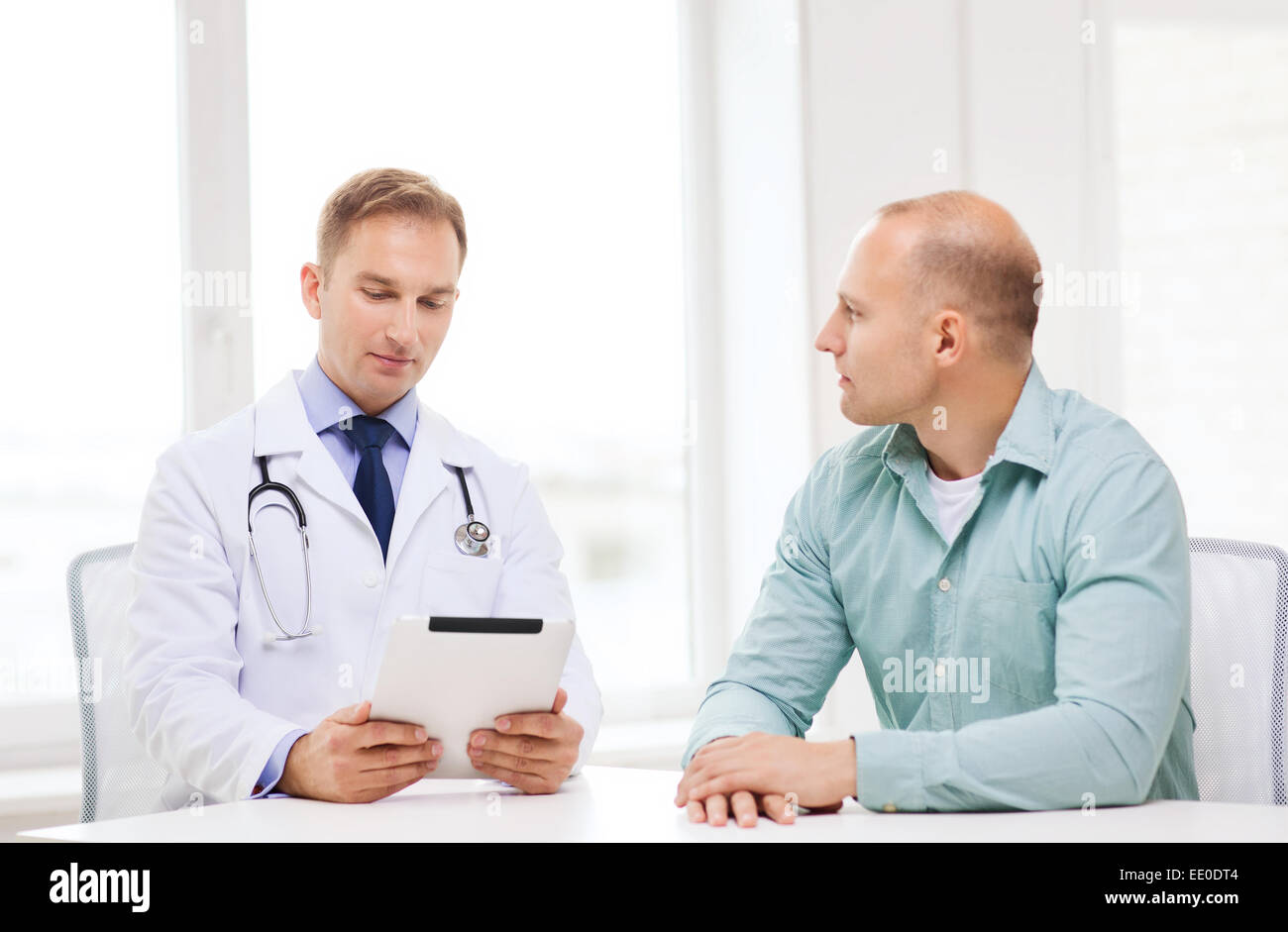 doctor with tablet pc and patient in hospital Stock Photo - Alamy