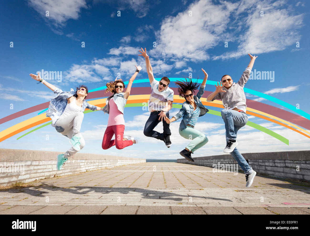 group of teenagers jumping Stock Photo - Alamy