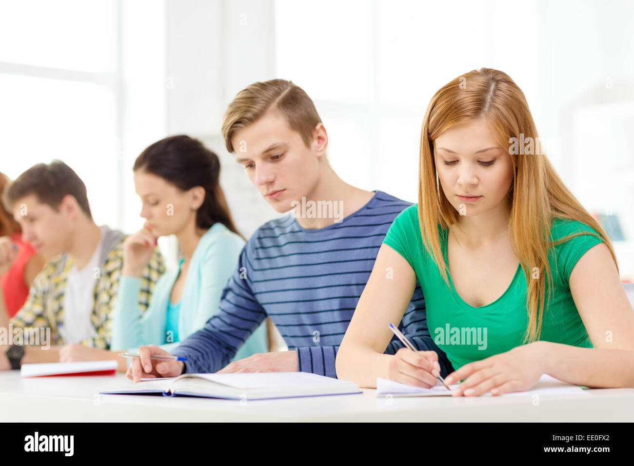 tired students with textbooks and books at school Stock Photo - Alamy