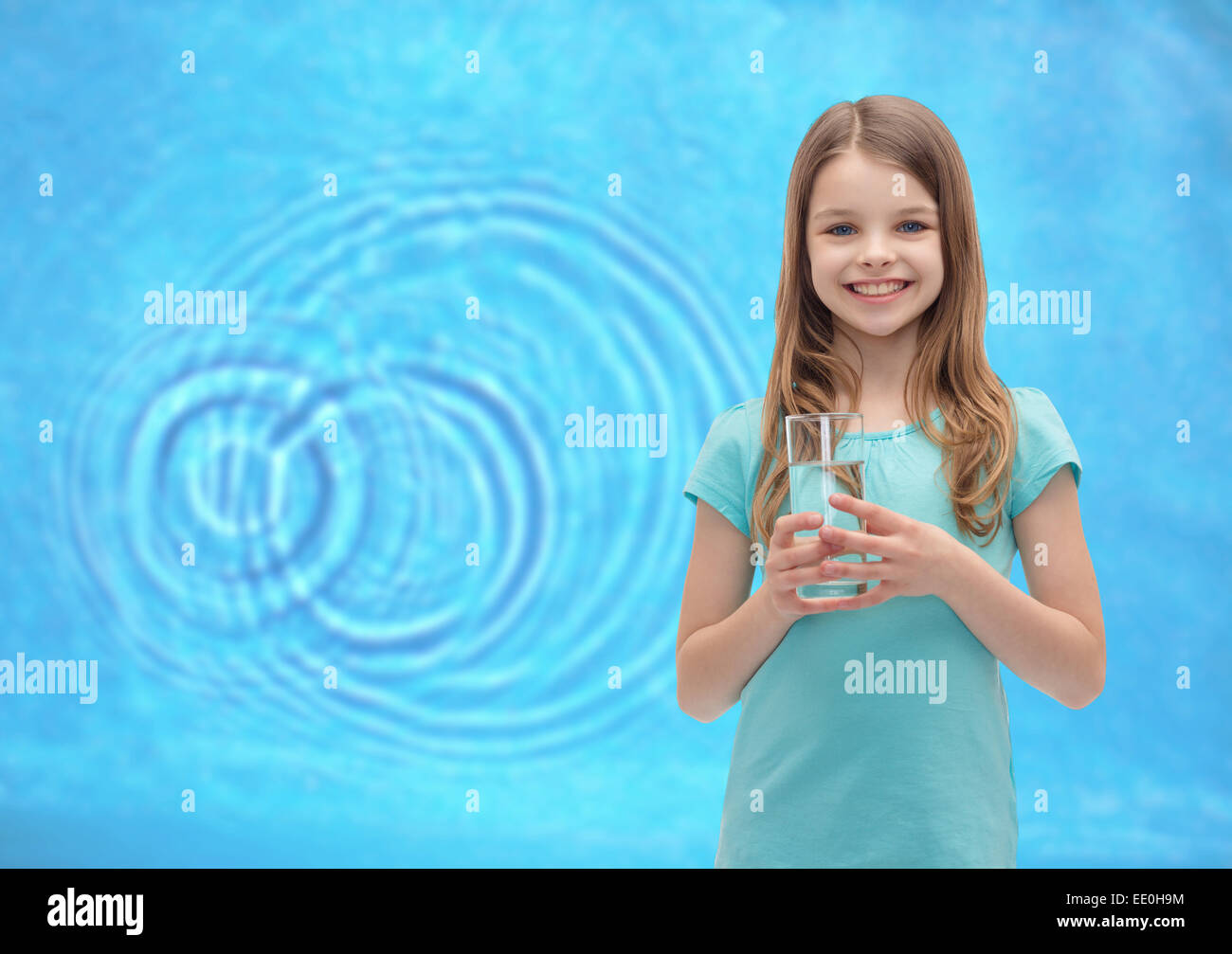 smiling little girl with glass of water Stock Photo - Alamy
