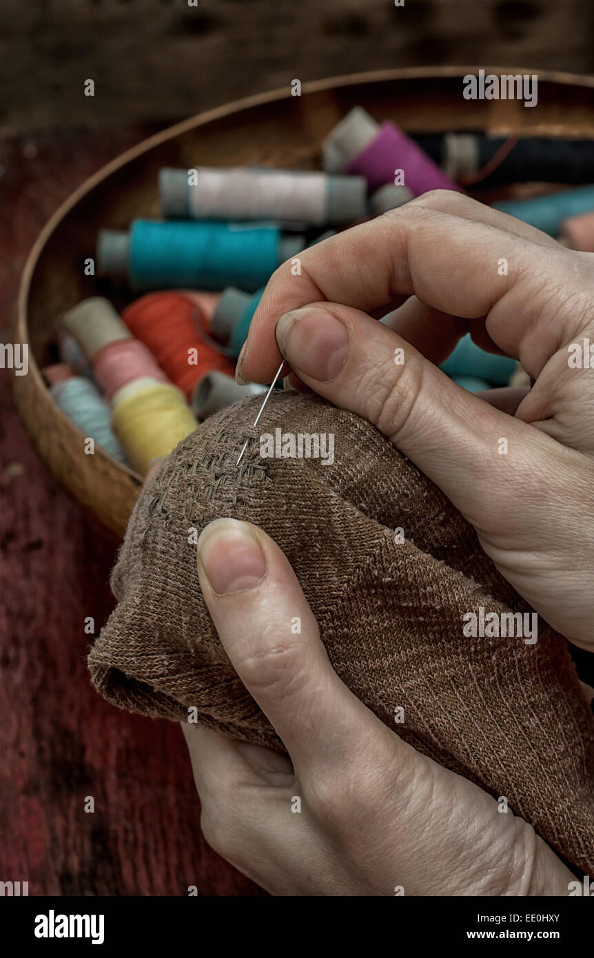 women's hands in the process stepania holey socks on the background of ...