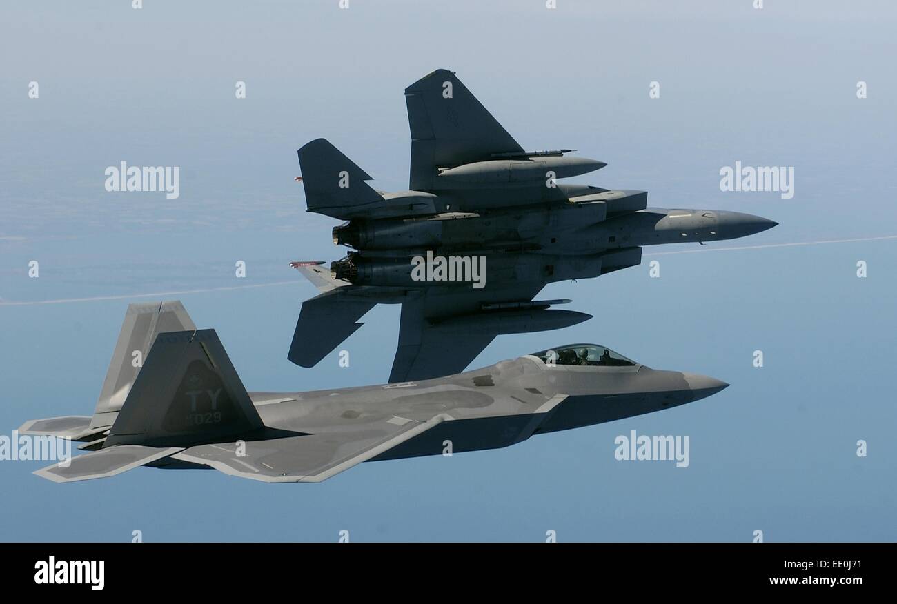 An F-15 Eagle fighter jet performs a left bank maneuver as it flies in ...