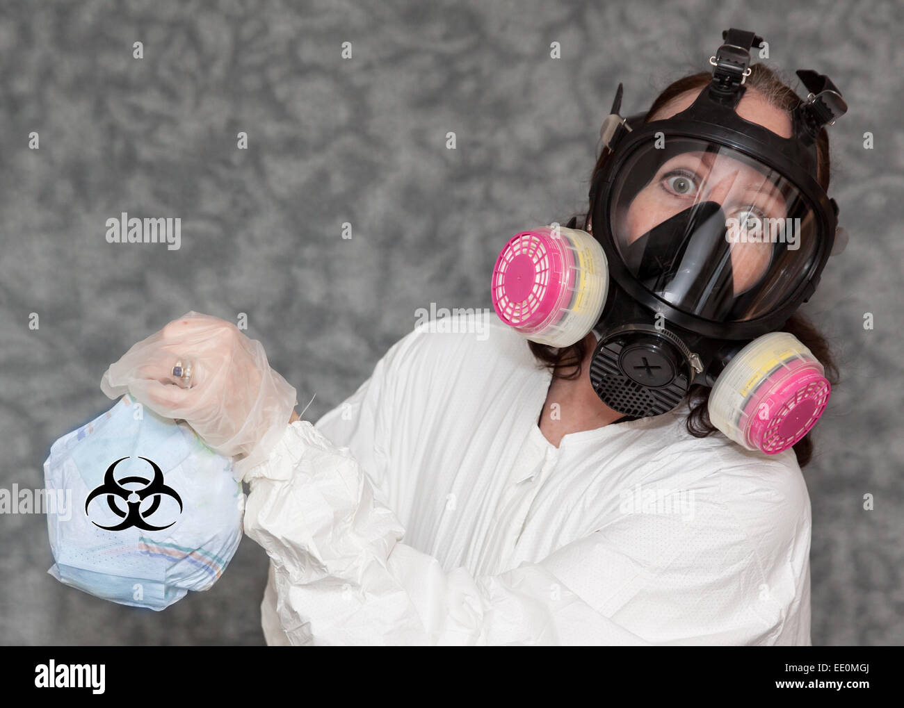 Concerned Woman with Gas Mask, gloves and Lab Coat holding Trash with ...