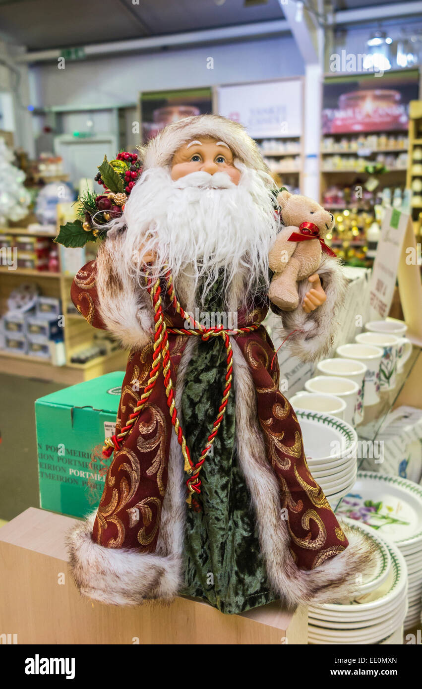 Traditional red-coated Santa Claus doll figure forming part of a shop ...