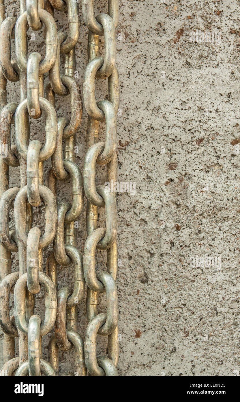 Chains against a cement background Stock Photo - Alamy