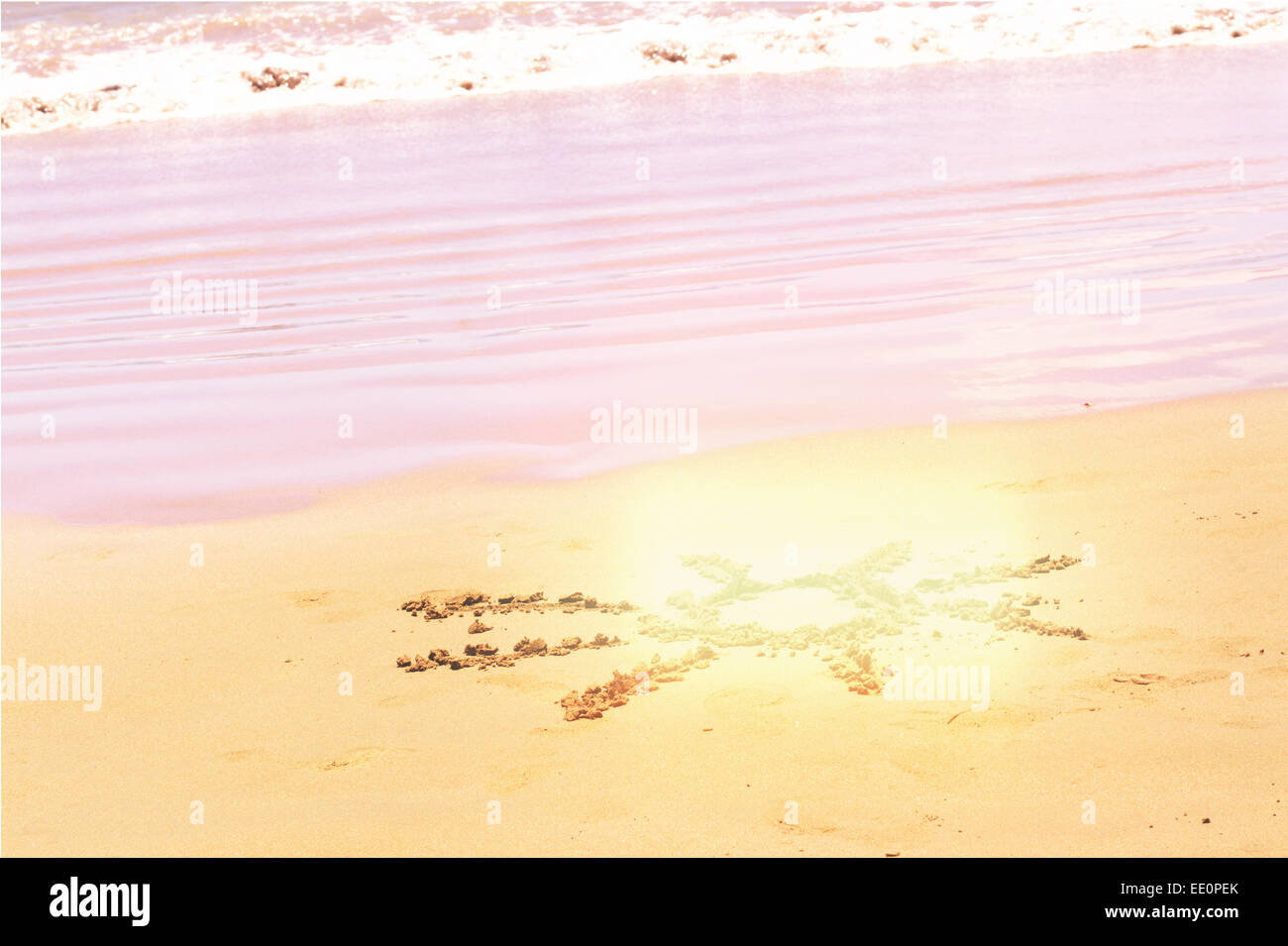 sun drawn on sandy beach Stock Photo - Alamy
