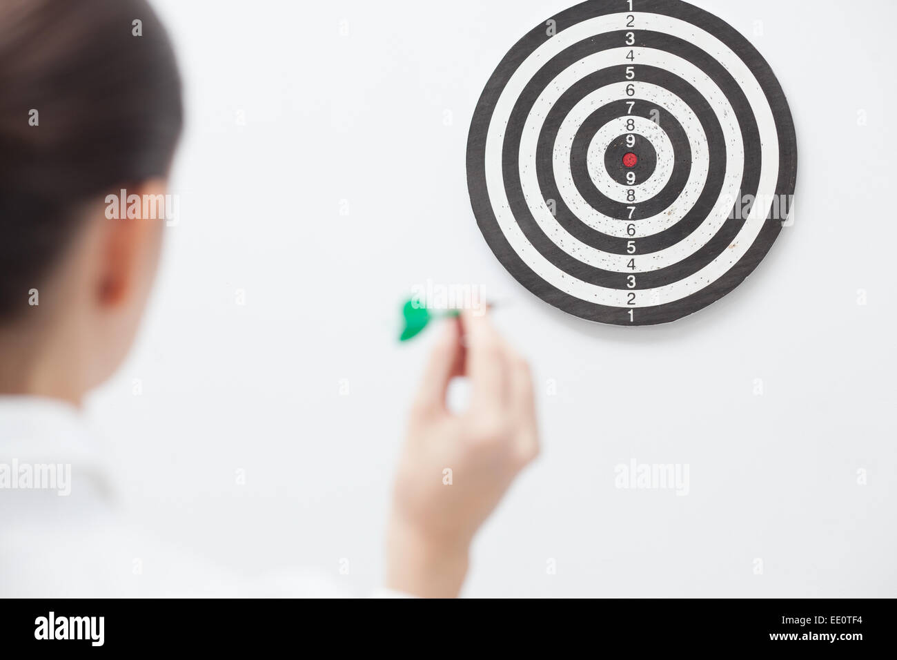 Businesswoman trying hit bullseye Stock Photo - Alamy