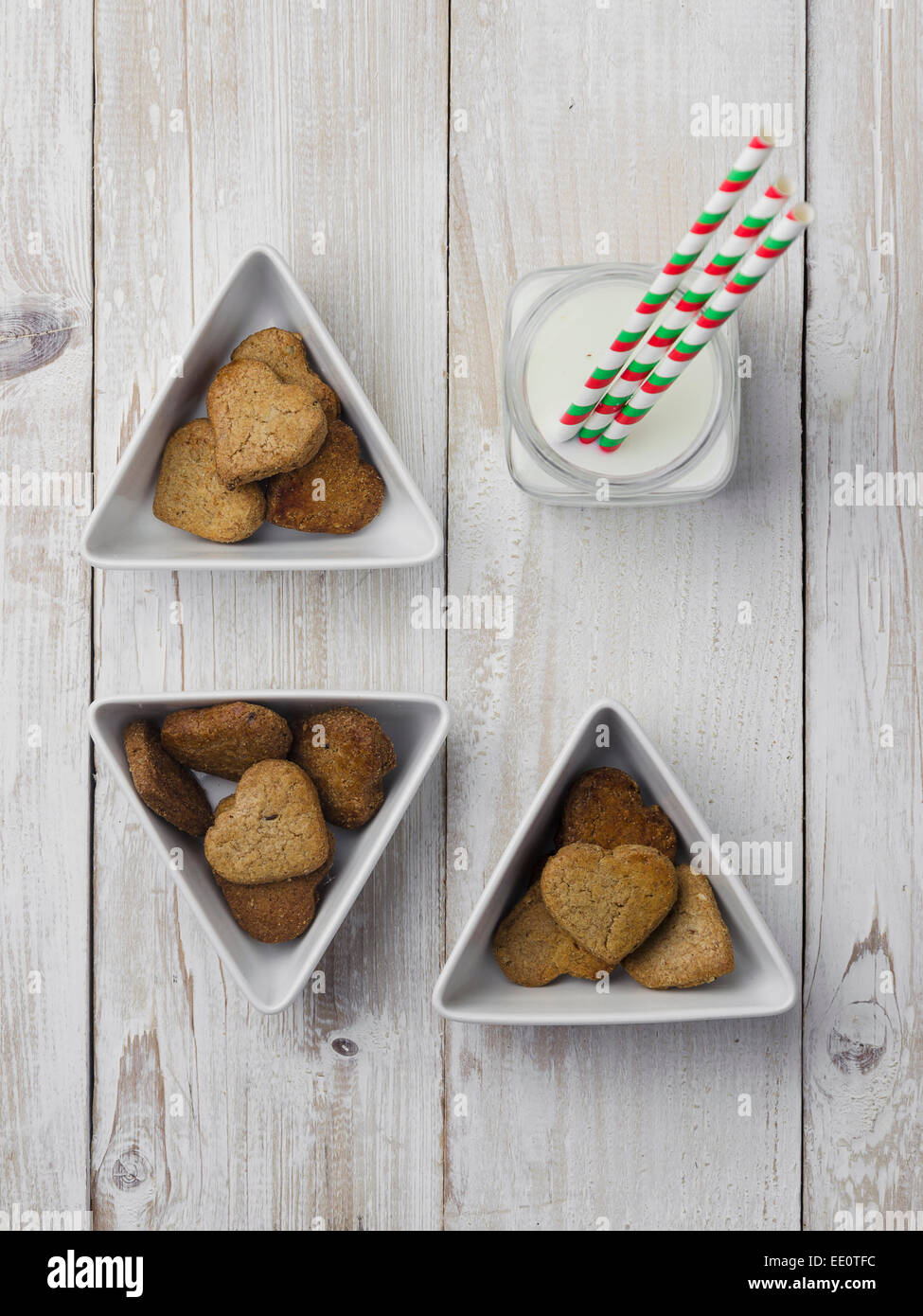 Homemade heart shaped cookies and milk over white wooden table Stock ...