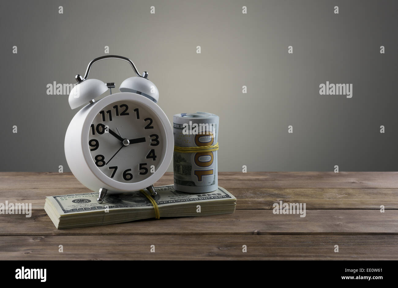 Time is money concept with clock and dollars Stock Photo - Alamy