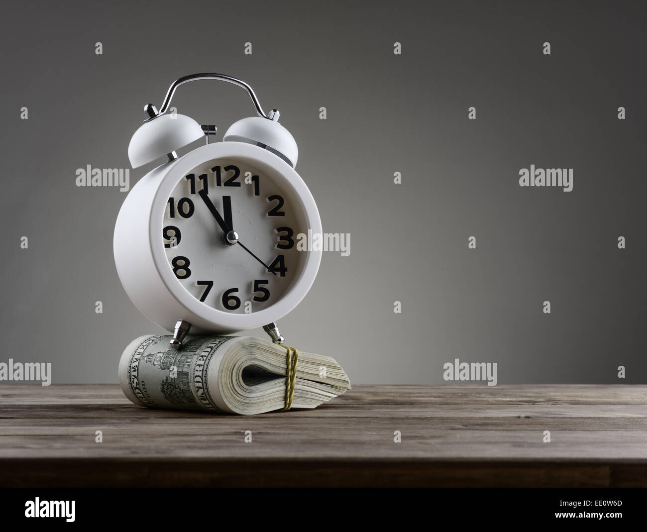 Time is money concept with clock and dollars Stock Photo - Alamy