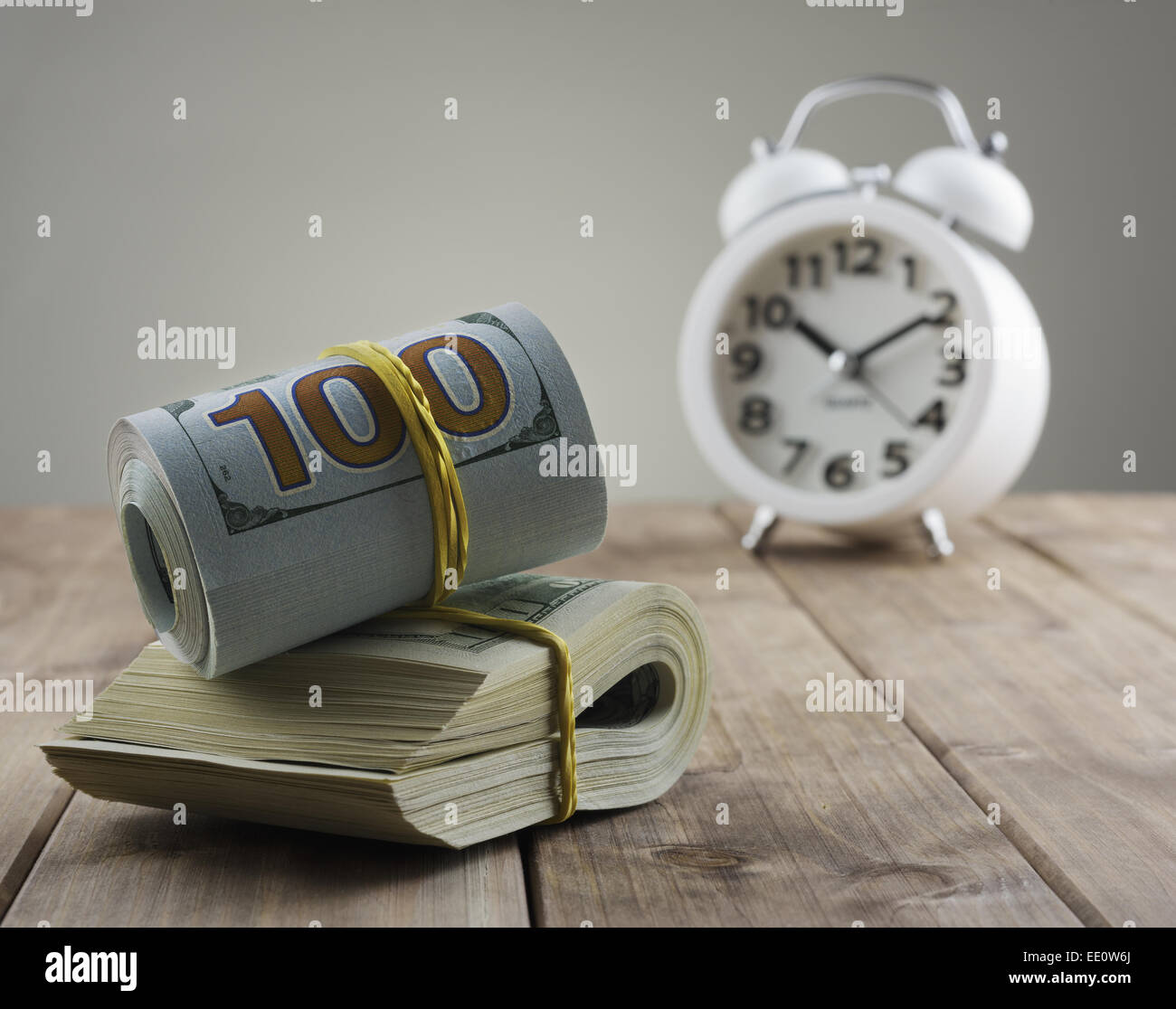 Time is money concept with clock and dollars Stock Photo - Alamy