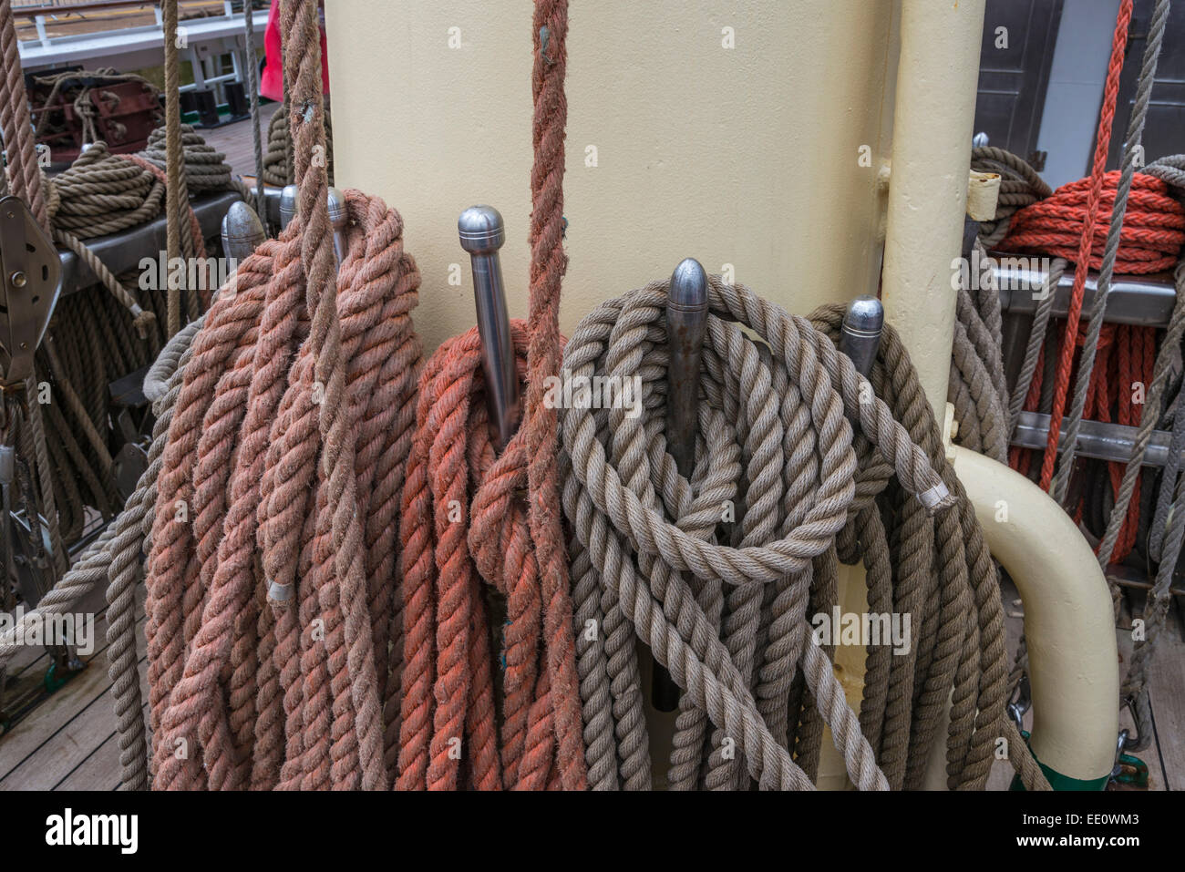 Ropes and belaying pins on the deck of a Tall Ship sailing vessel ...