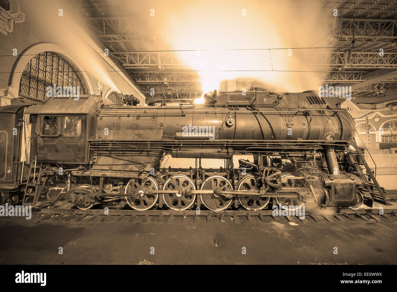 Steam train arrives to the station at night time. Vintage image Stock ...