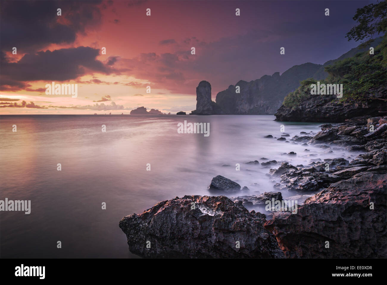 Dramatic sunset rays through a cloudy dark sky and mountains over the ...