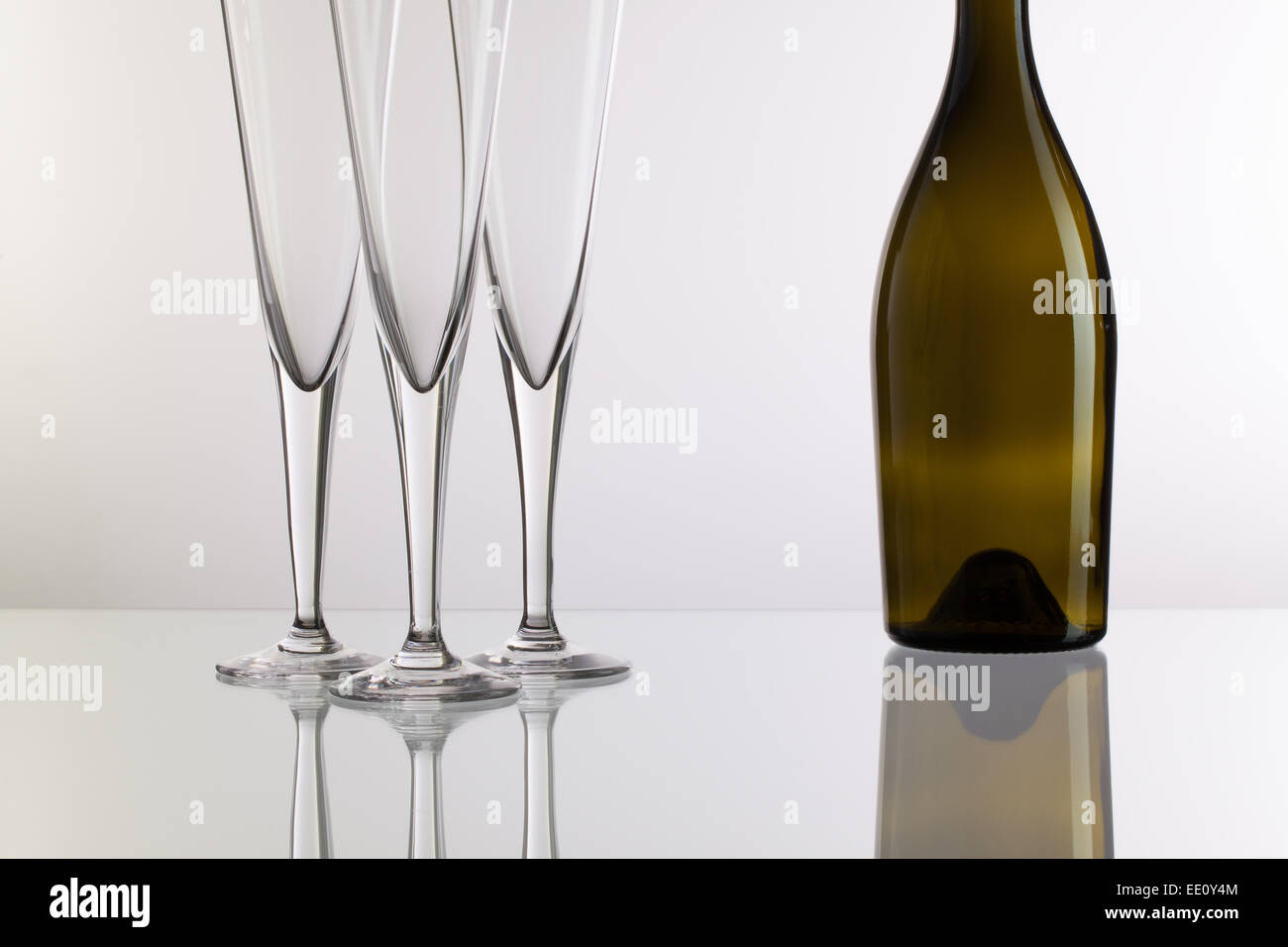 Empty champagne glasses on the glass desk Stock Photo - Alamy