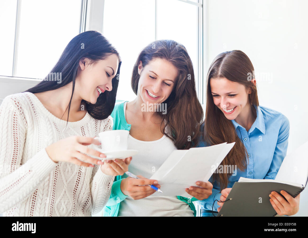 Group of female students studying together at home Stock Photo - Alamy