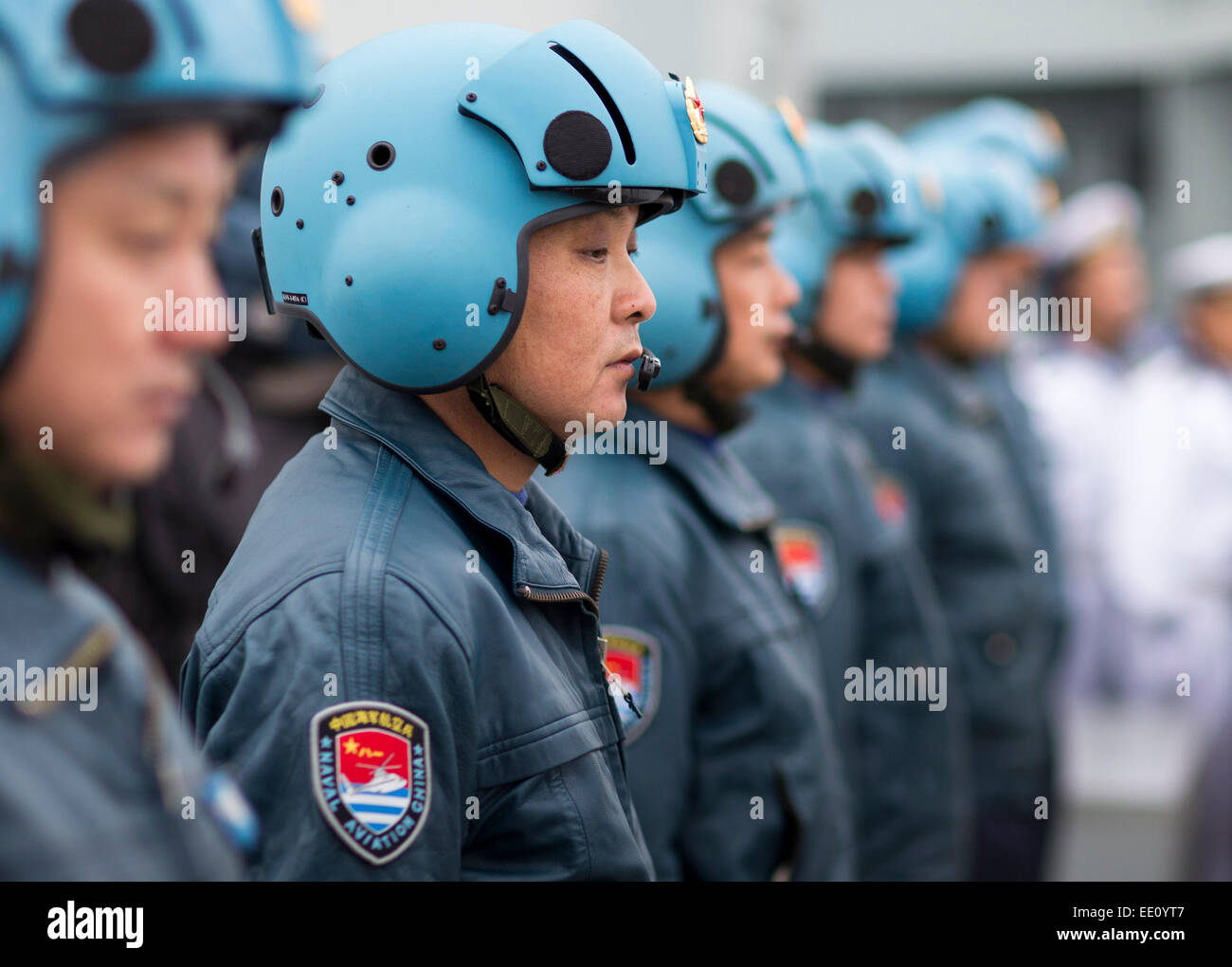 Helicopter pilots and flight crew stand to attention aboard the Chinese ...