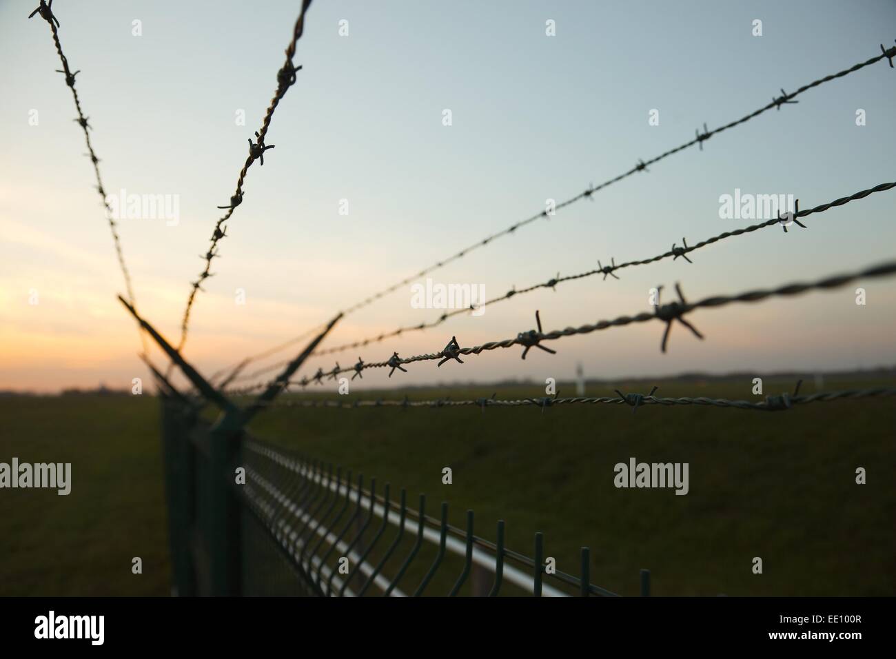 Security fence barb wire sunset hi-res stock photography and images - Alamy