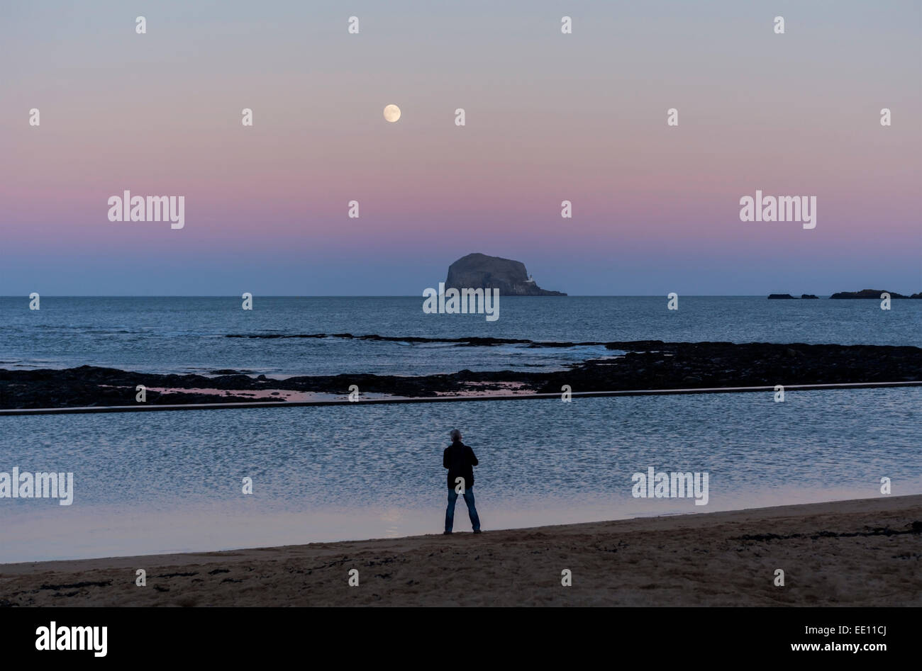 Moon over silhouette rocks in hi-res stock photography and images - Alamy