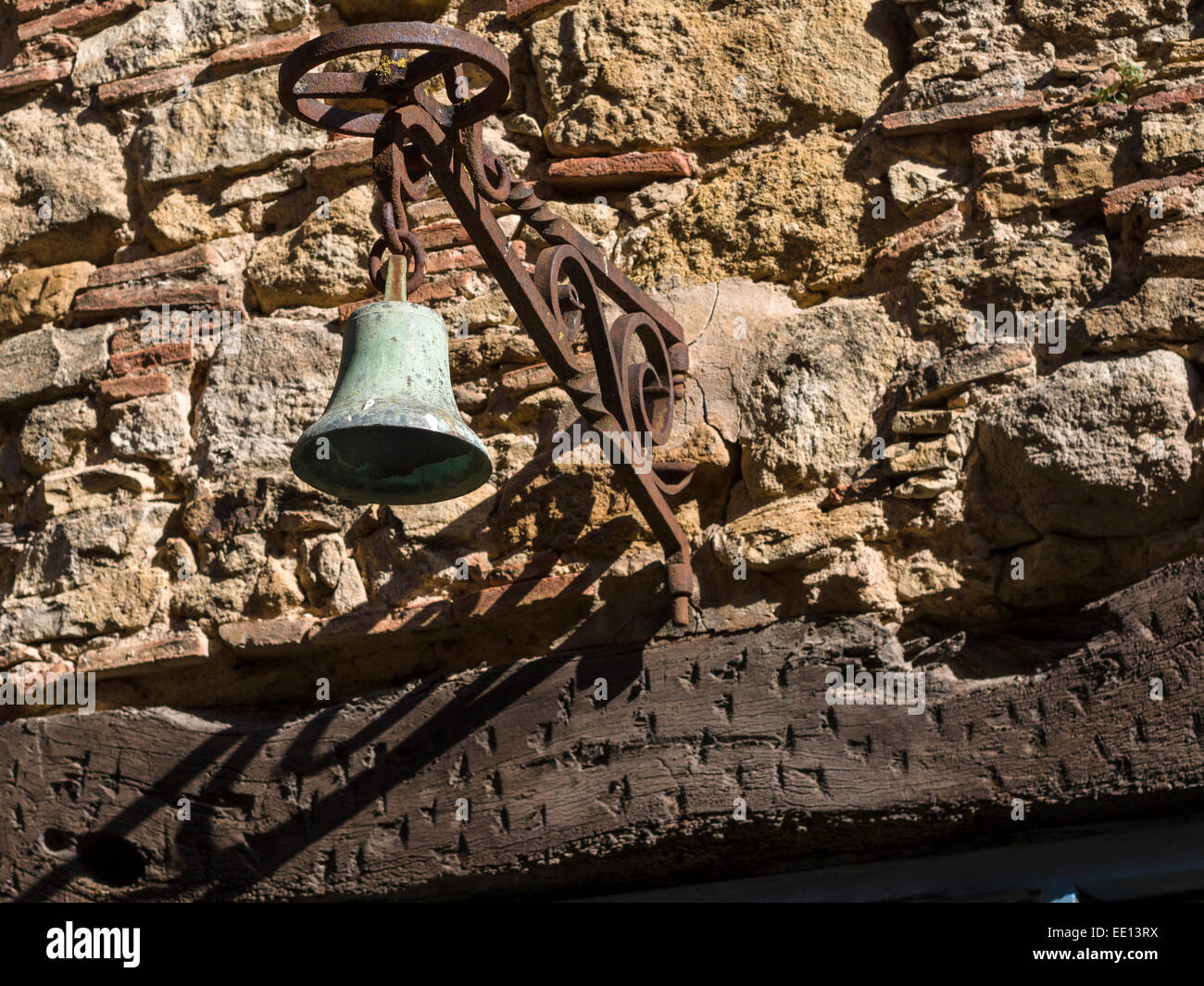 Door bell. A brass bell hung over a house door with an elaborate ...