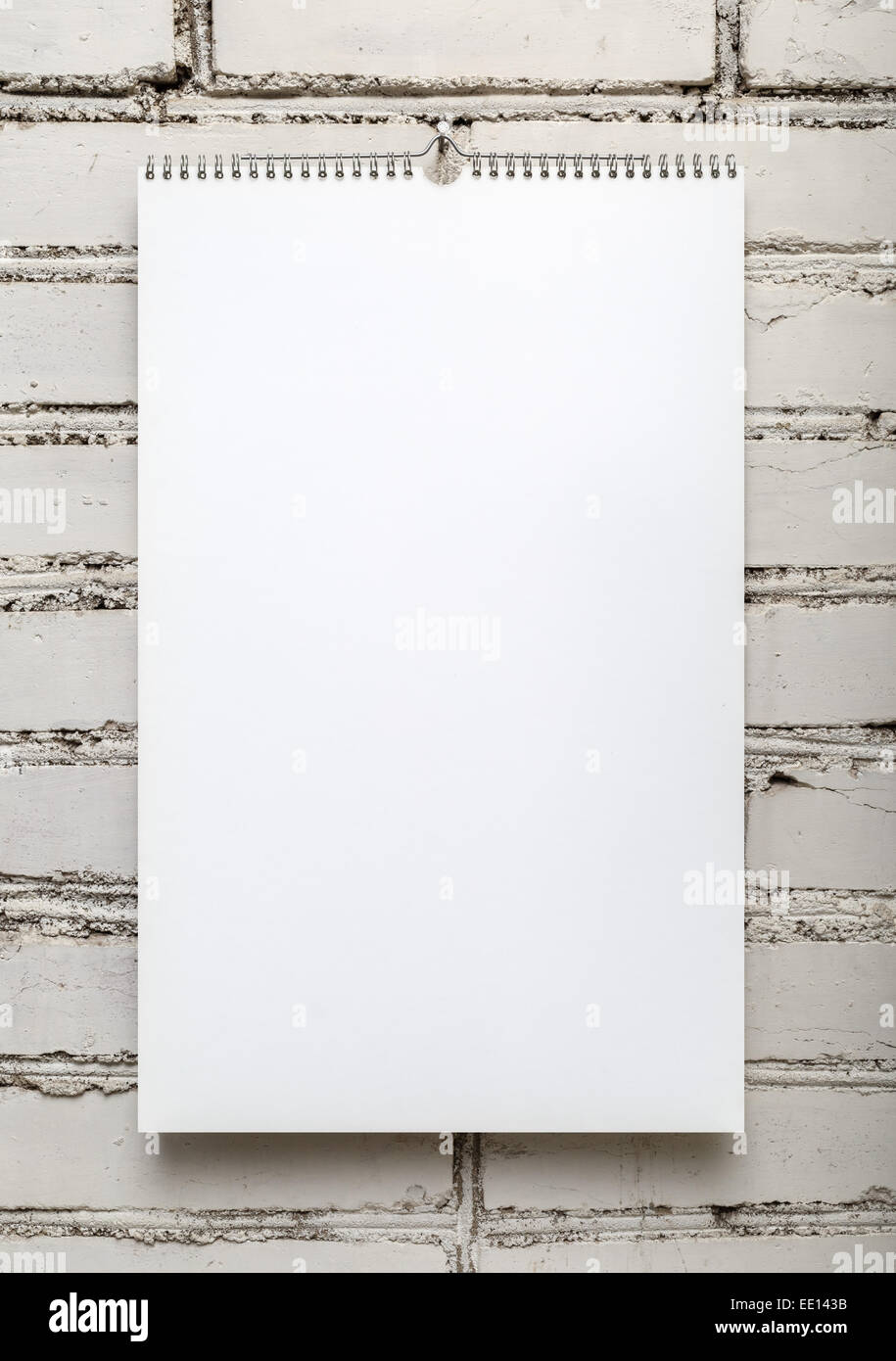 Blank album on a spring against a white brick wall. Template for design ...
