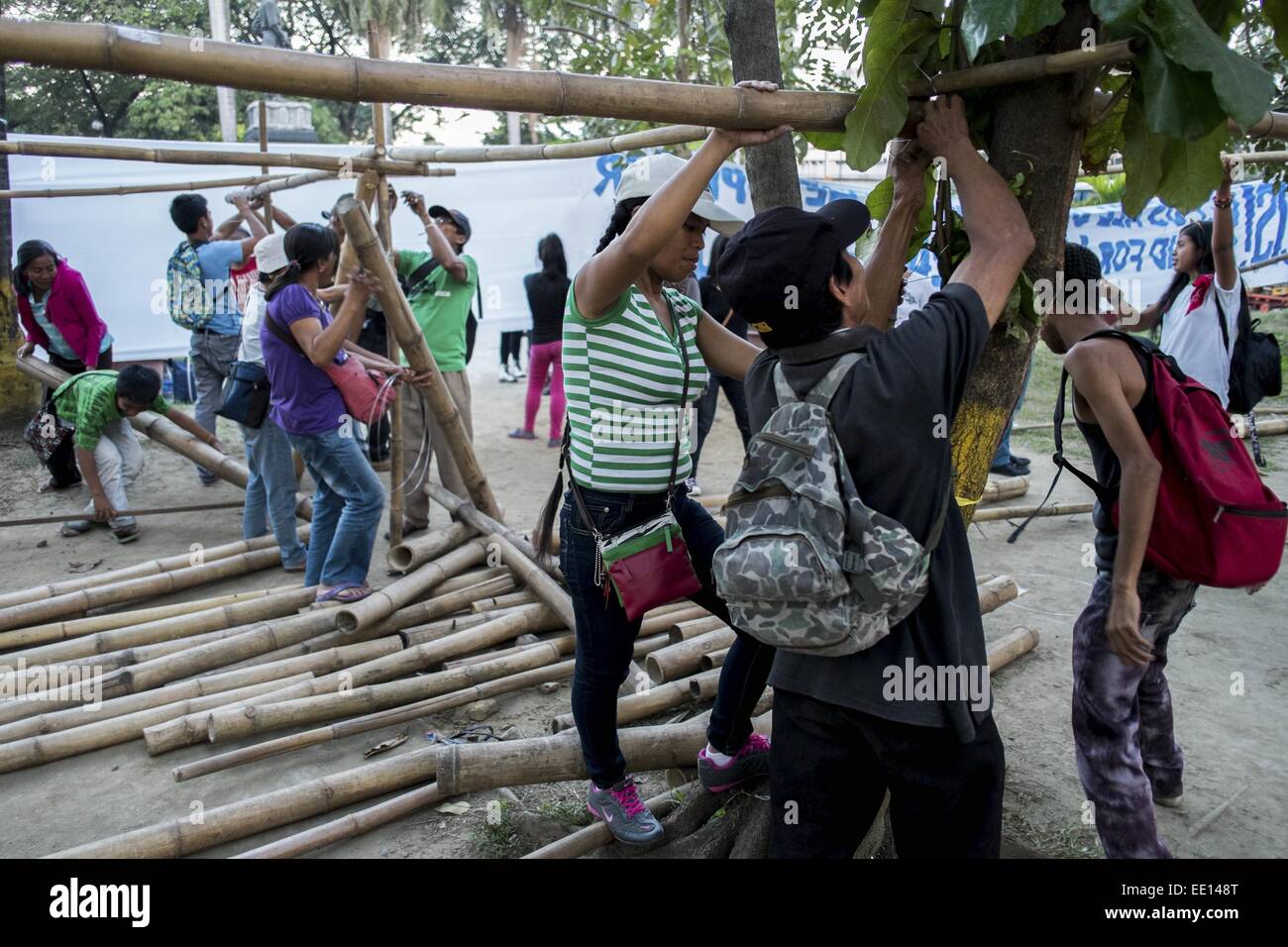 Peasants from southern tagalog build their temporary shelter at the ...