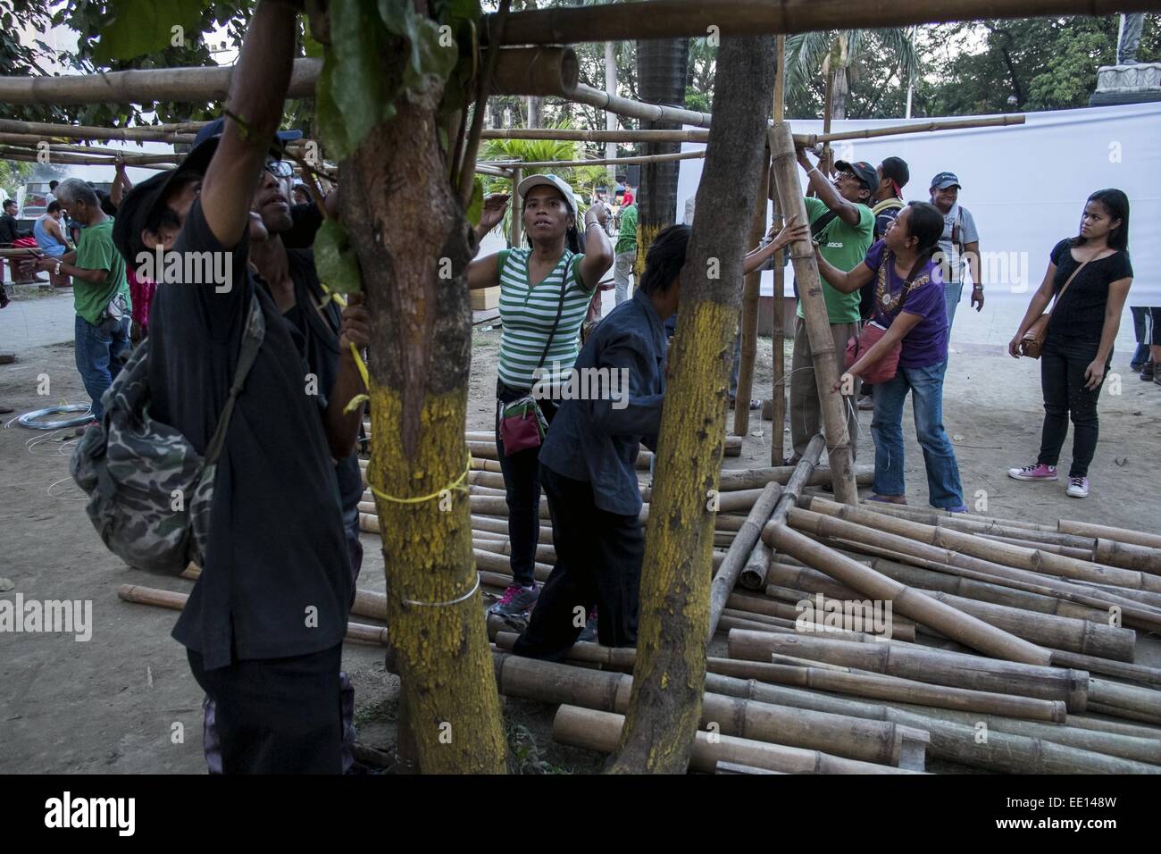 Peasants from southern tagalog build their temporary shelter at the ...