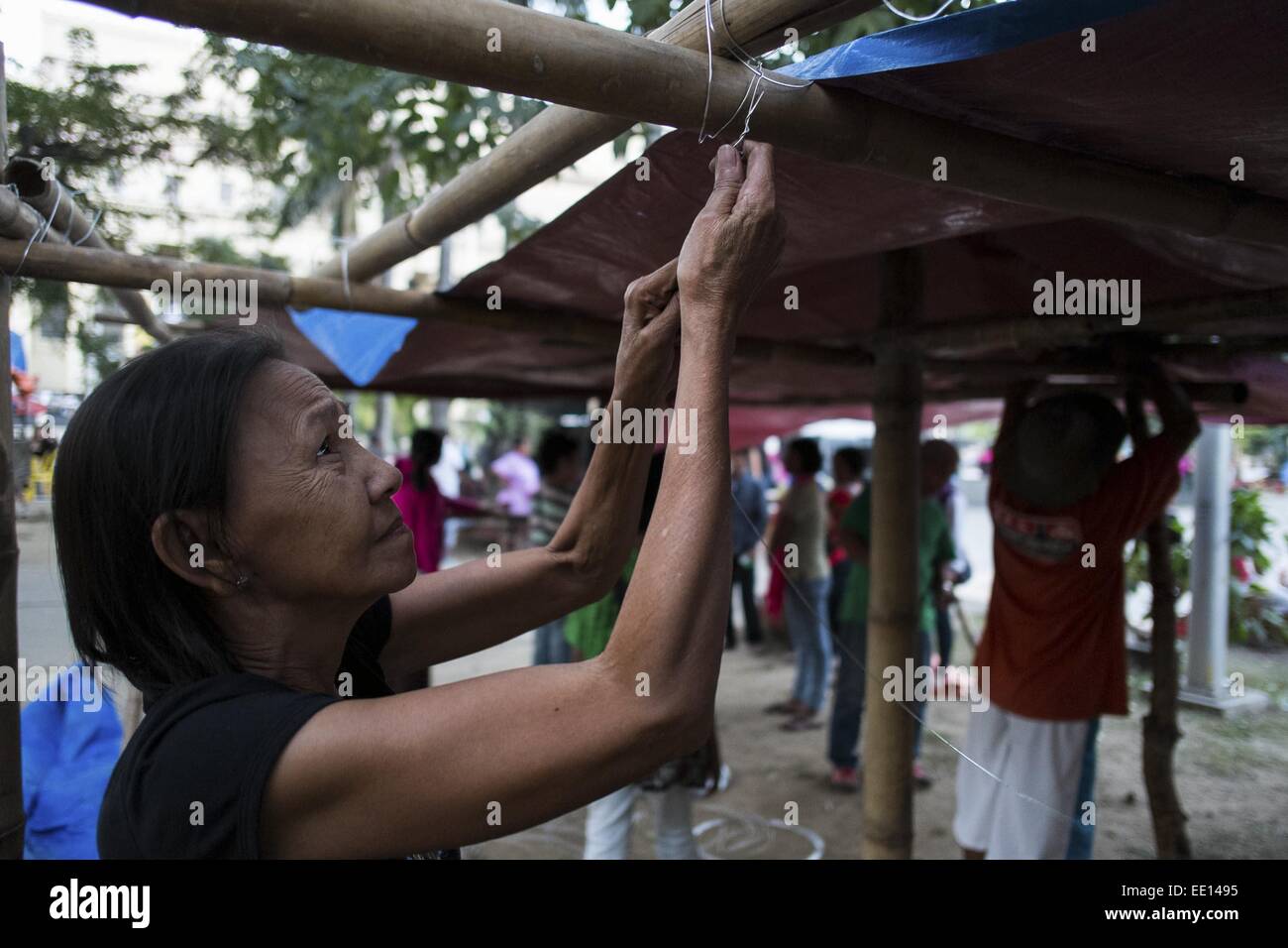 Peasants from southern tagalog build their temporary shelter at the ...