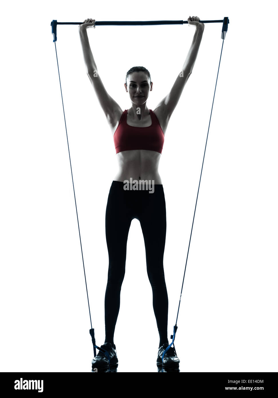 one caucasian woman exercising elastic gymstick in silhouette studio ...