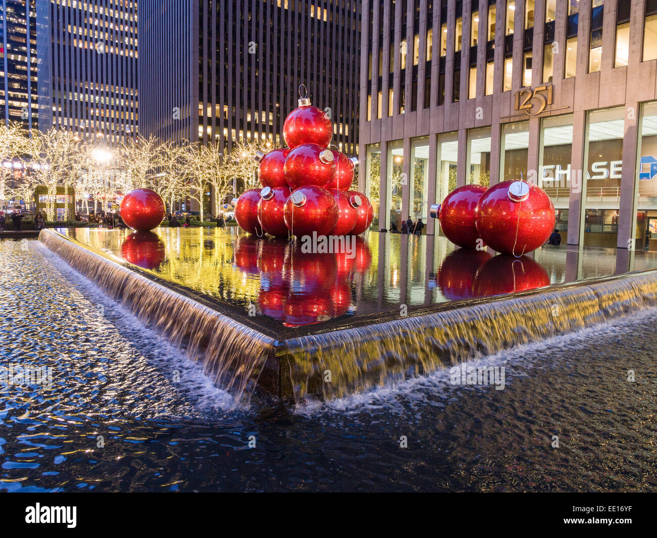 Red Giant Christmas Balls in a reflecting pool. Evening view of huge ...
