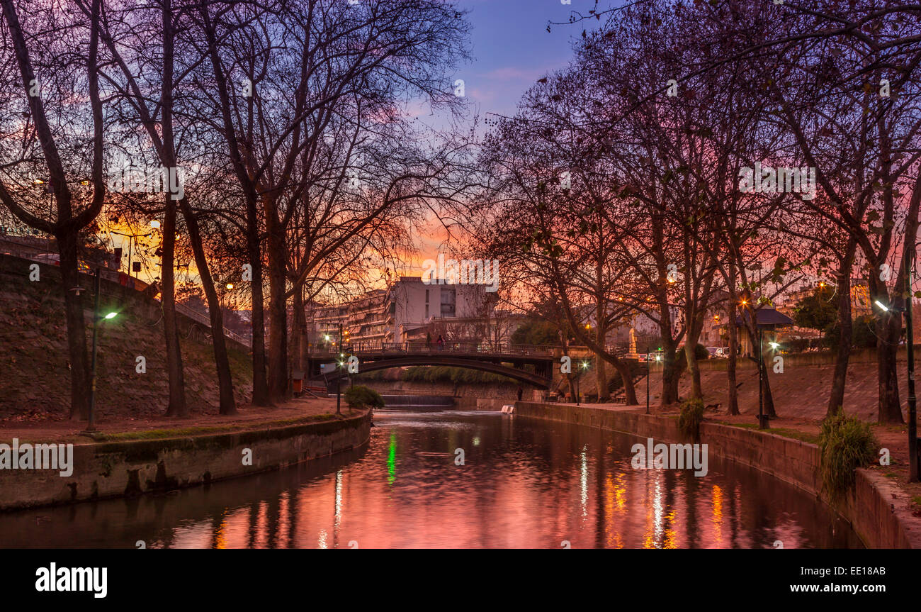 A winter sunset in the river Litheos, in the heart of the city of ...