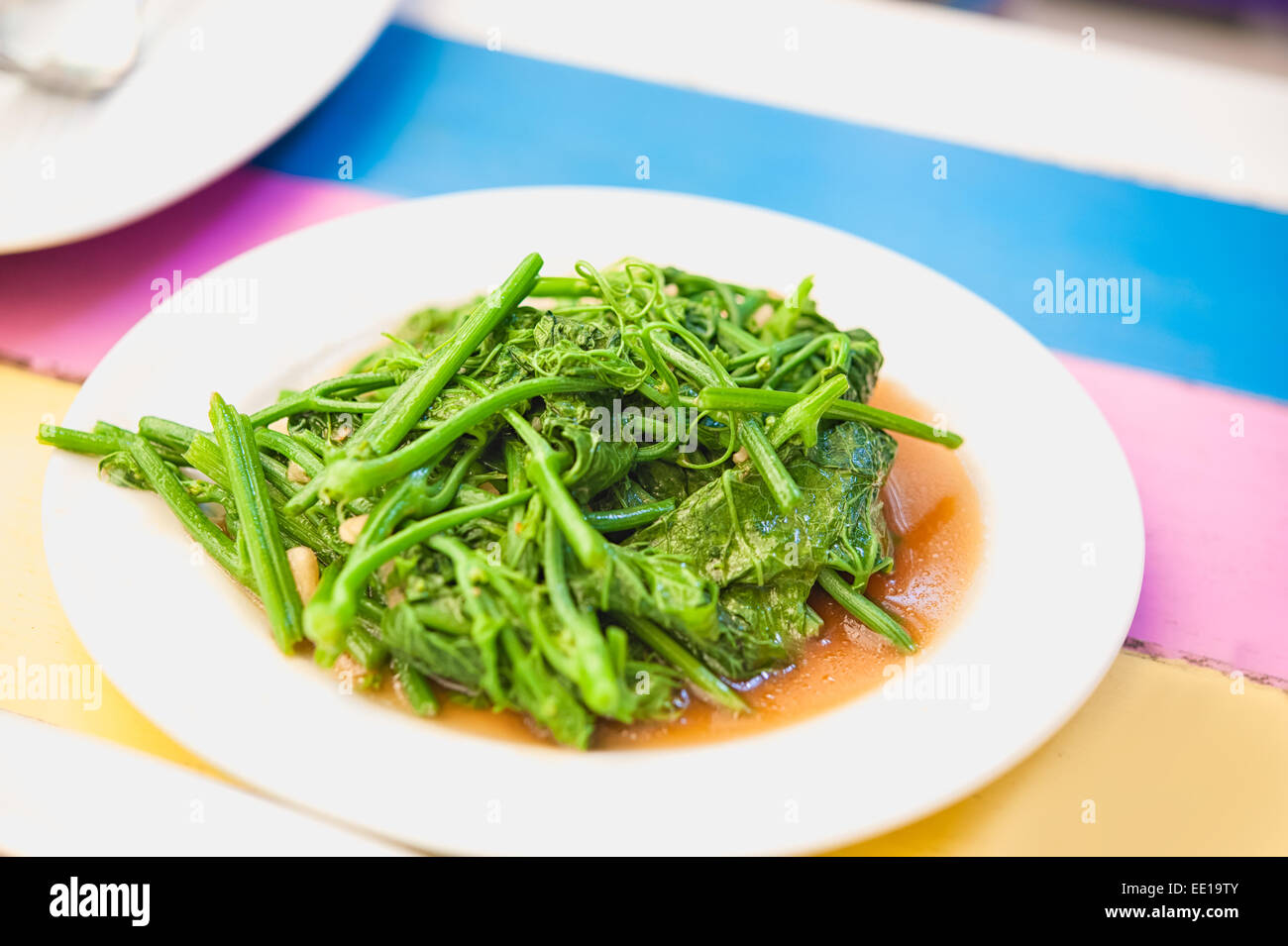 Closeup of stir fried young chayote leaf with garlic Stock Photo - Alamy