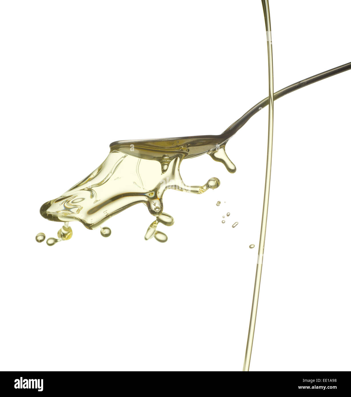 Pouring oil splash. Isolated on white background Stock Photo - Alamy