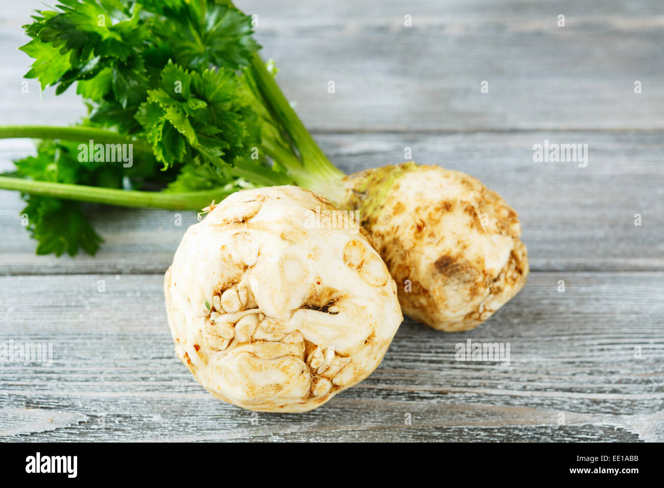 Two raw celery on the boards, wooden background Stock Photo - Alamy