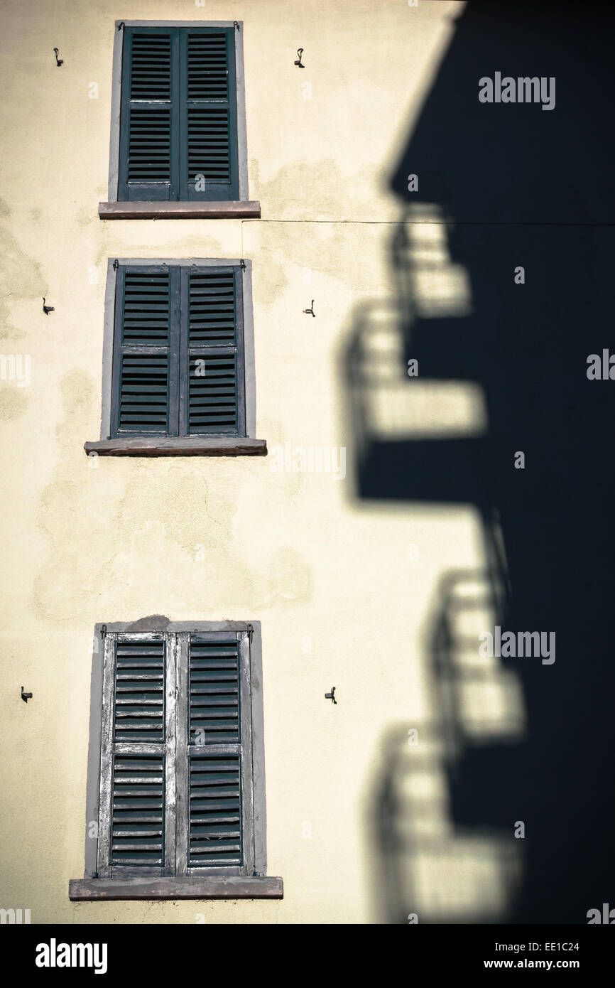 The shadow of a building is projected on the building in front of him ...