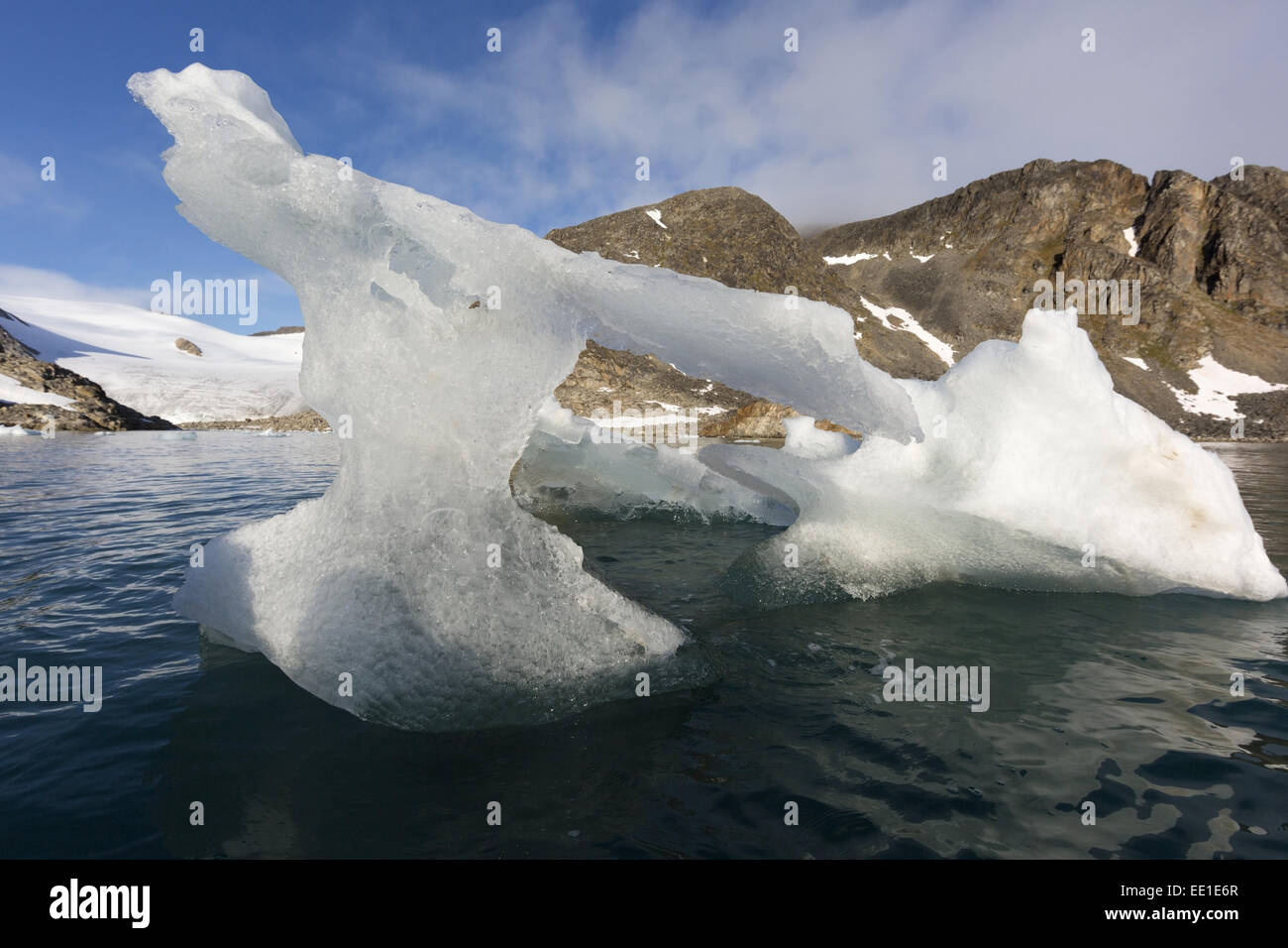Melting glacial iceberg in fjord, Raudfjorden, Spitsbergen, Svalbard ...