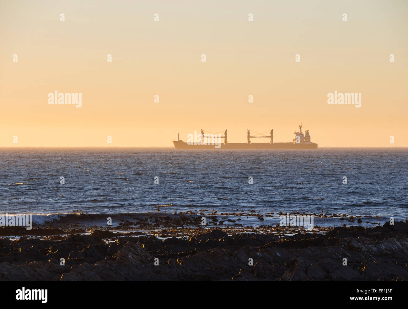 Large boat out at sea at sunset Stock Photo - Alamy