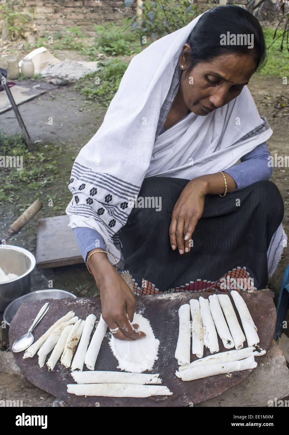 Sivasagar, Assam, India. 13th Jan, 2015. An Assamese woman prepares ...