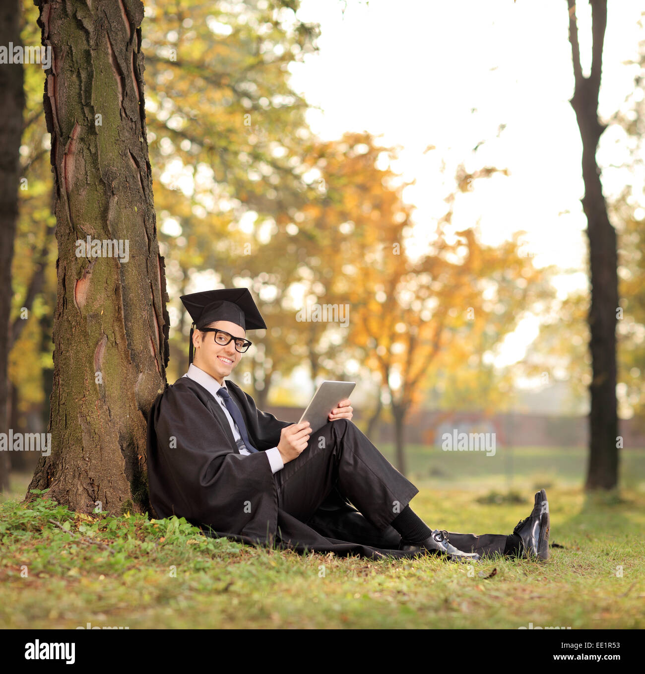 Playing tablet man in park hi-res stock photography and images - Alamy